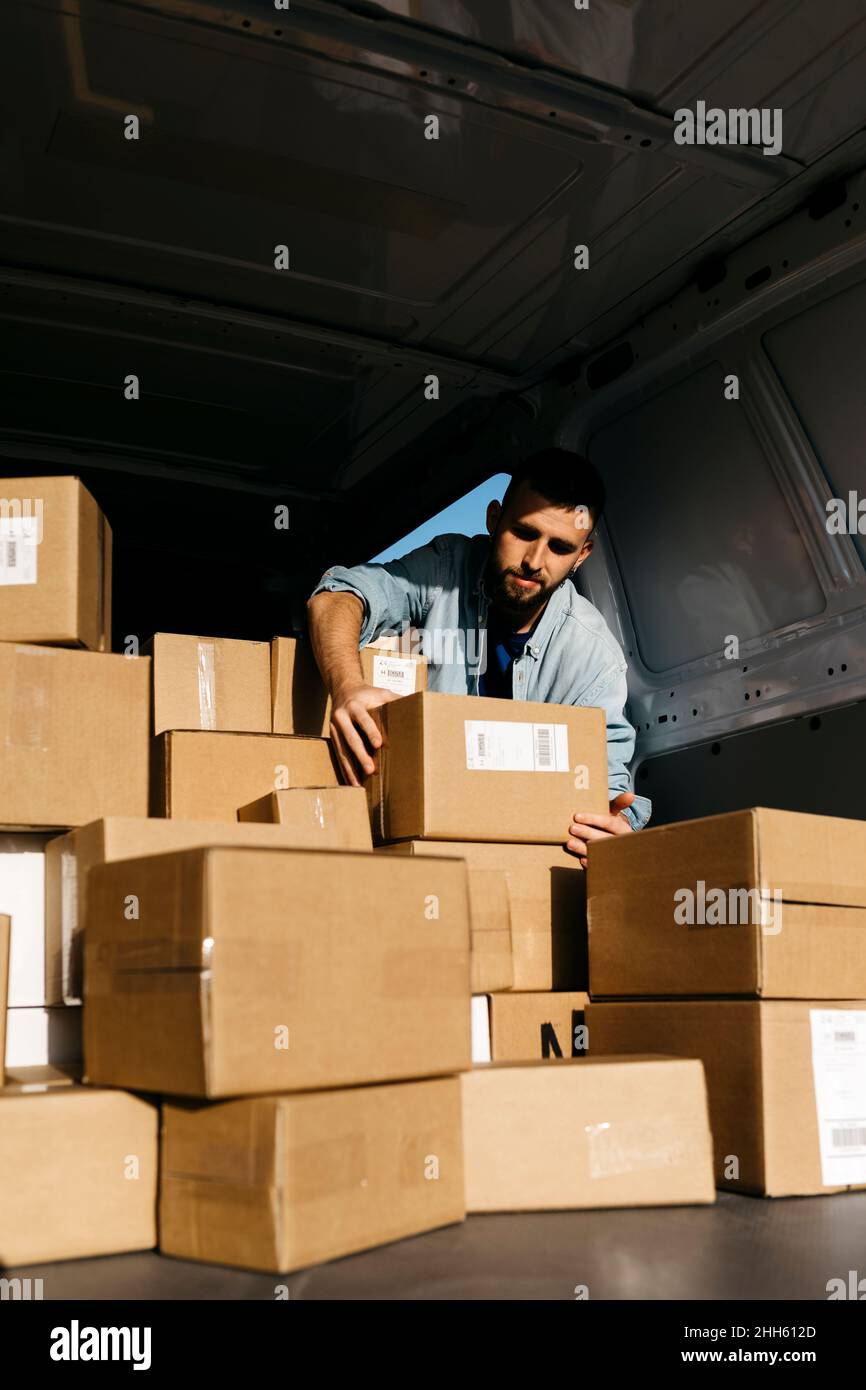 Male picking up box from hi-res stock photography and images - Alamy