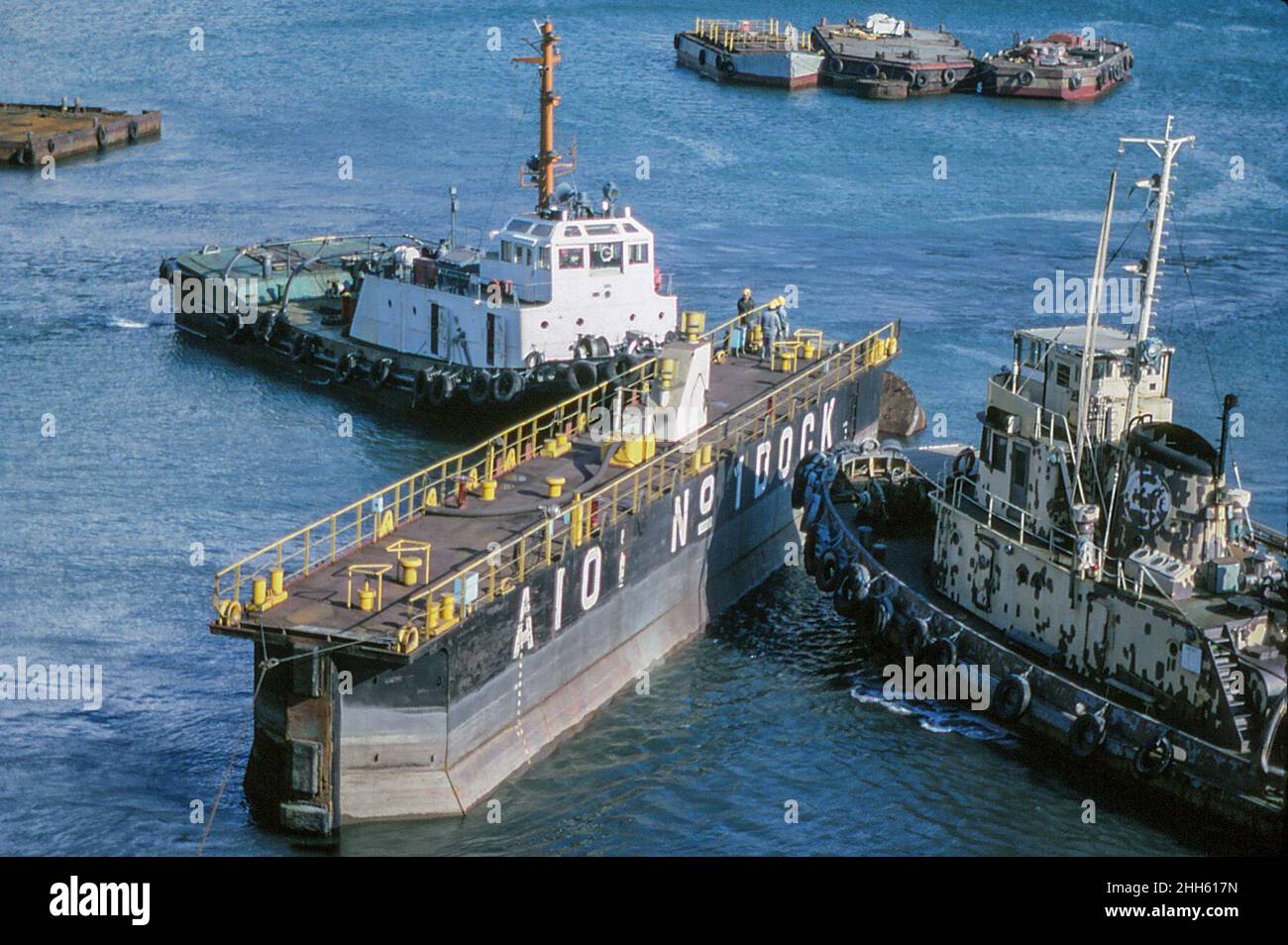 Dry dock gate being maneuvered by tugs at Aioi shipyard, Japan, 3rd ...
