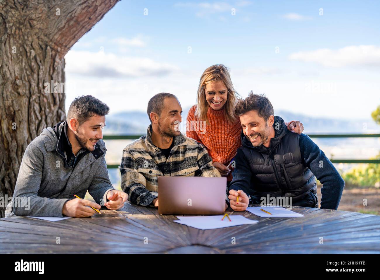 Four men sitting around table hi-res stock photography and images - Alamy