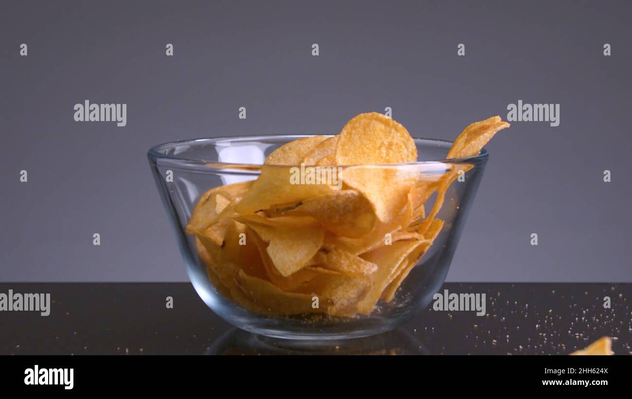 Chips falling on isolated background. Stock footage. Delicious chips ...