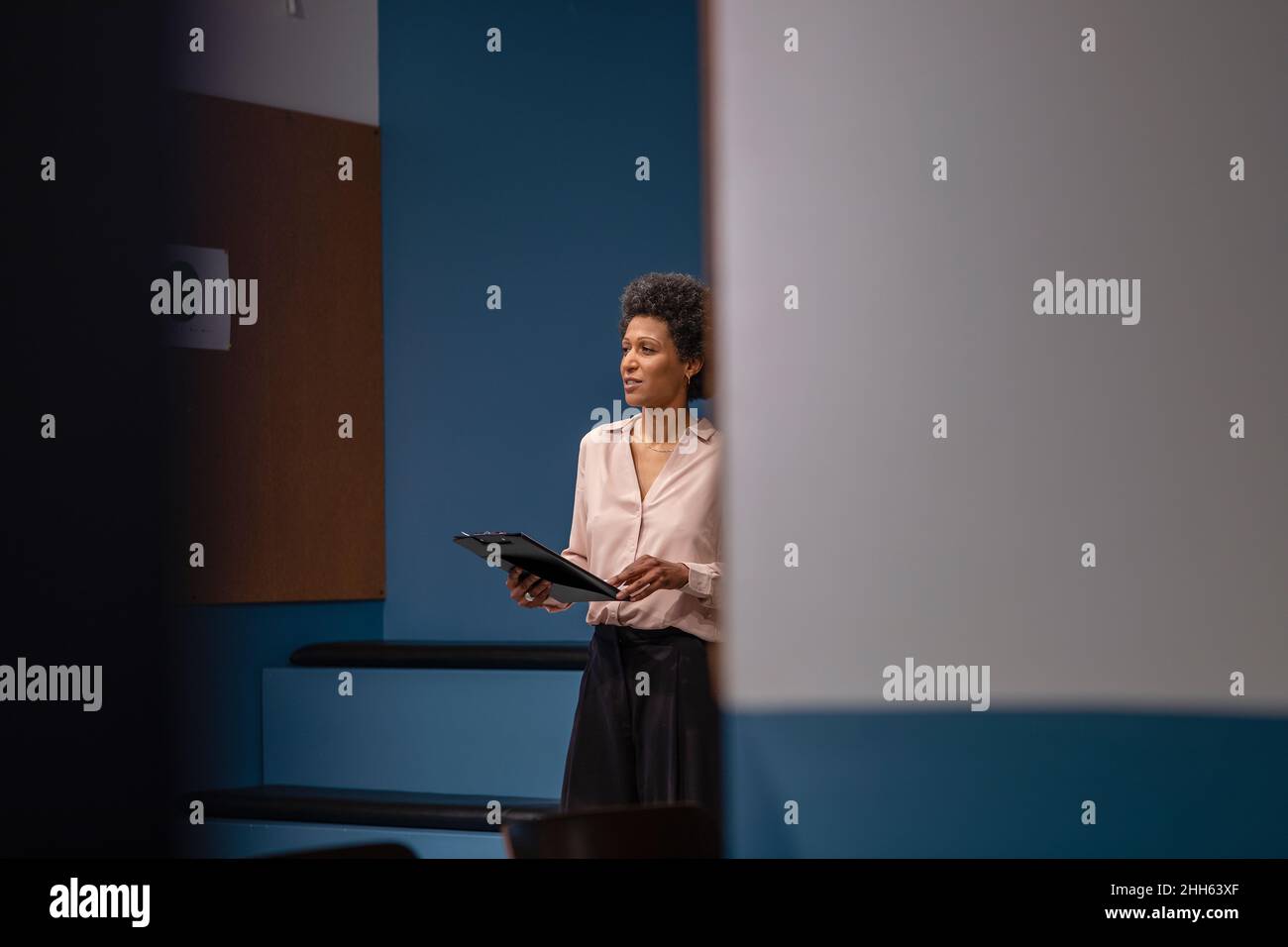Businesswoman practicing speech in office board room Stock Photo - Alamy
