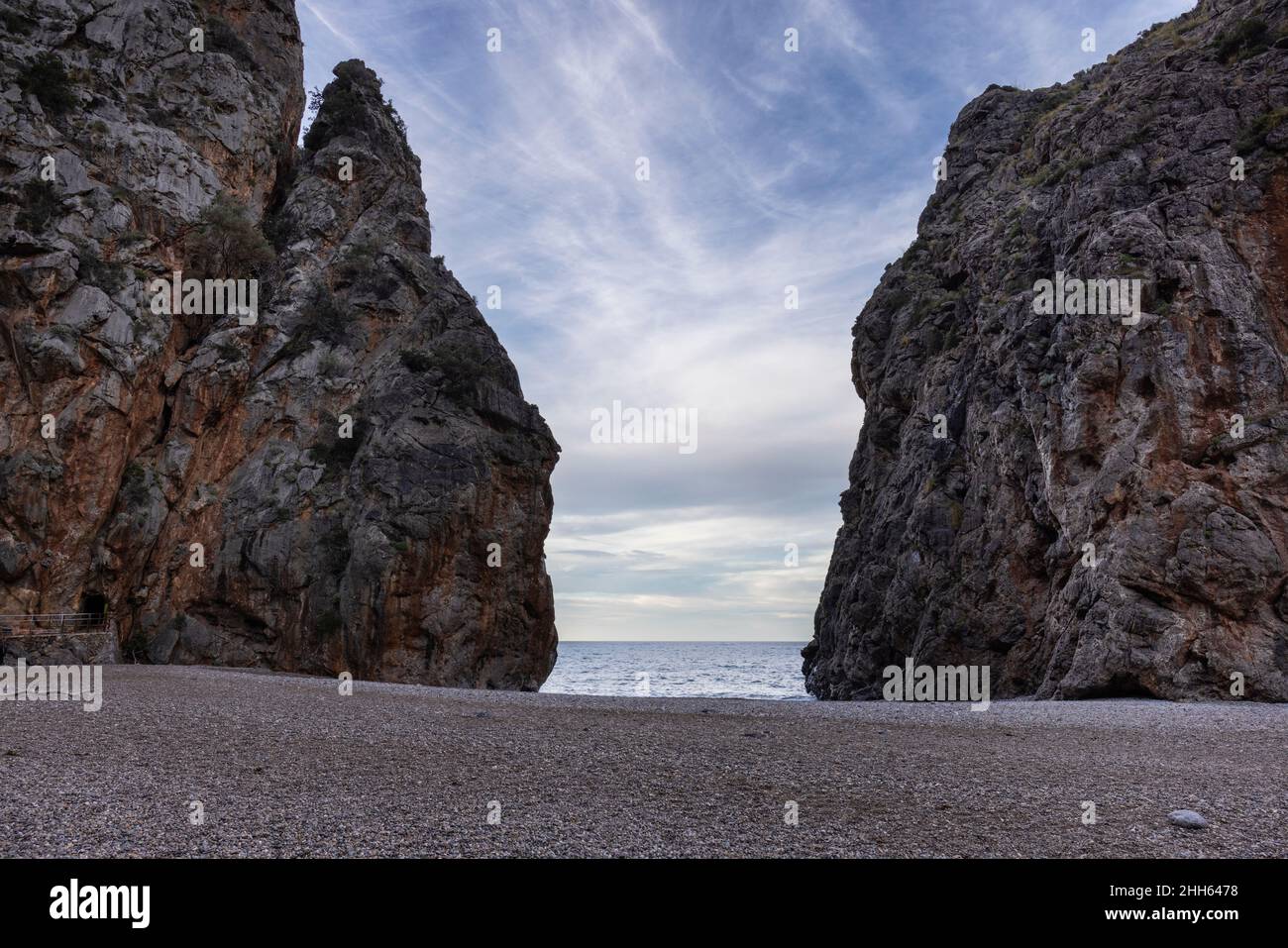 Rock formations on beach at sunset Stock Photo - Alamy