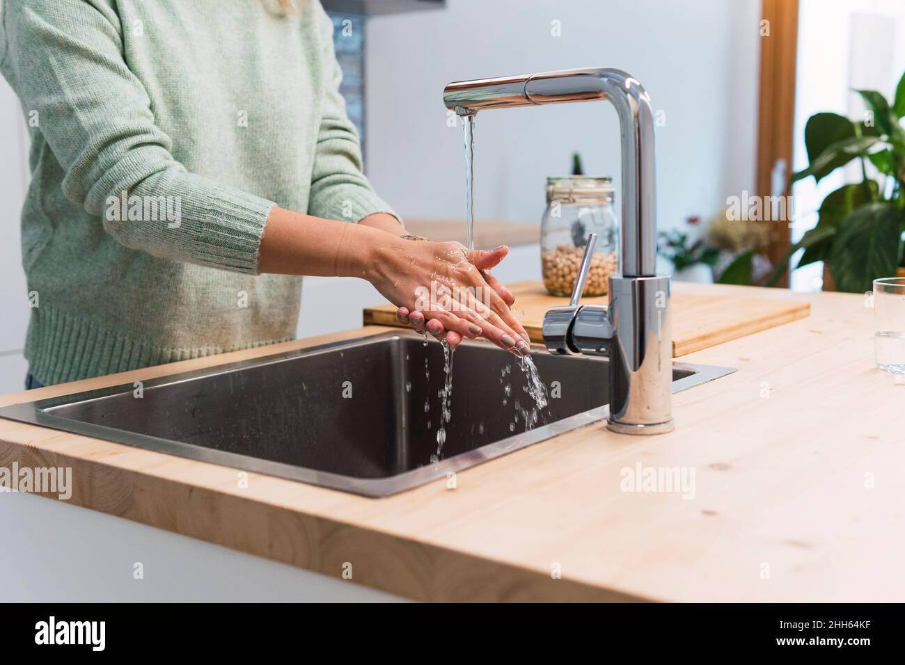Woman washing hands kitchen hi-res stock photography and images - Alamy