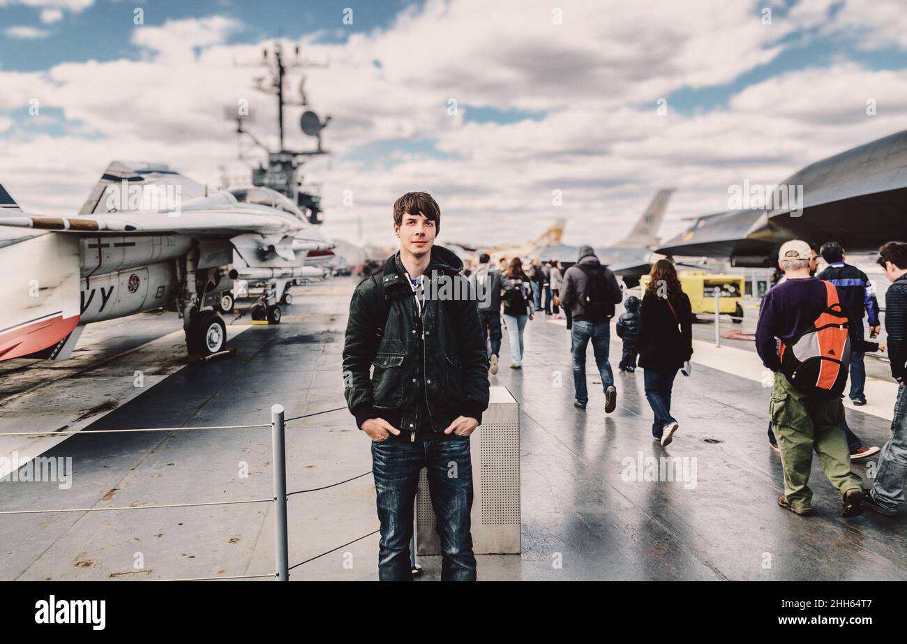 Young adult man with brown hair and beard standing on the top of ...