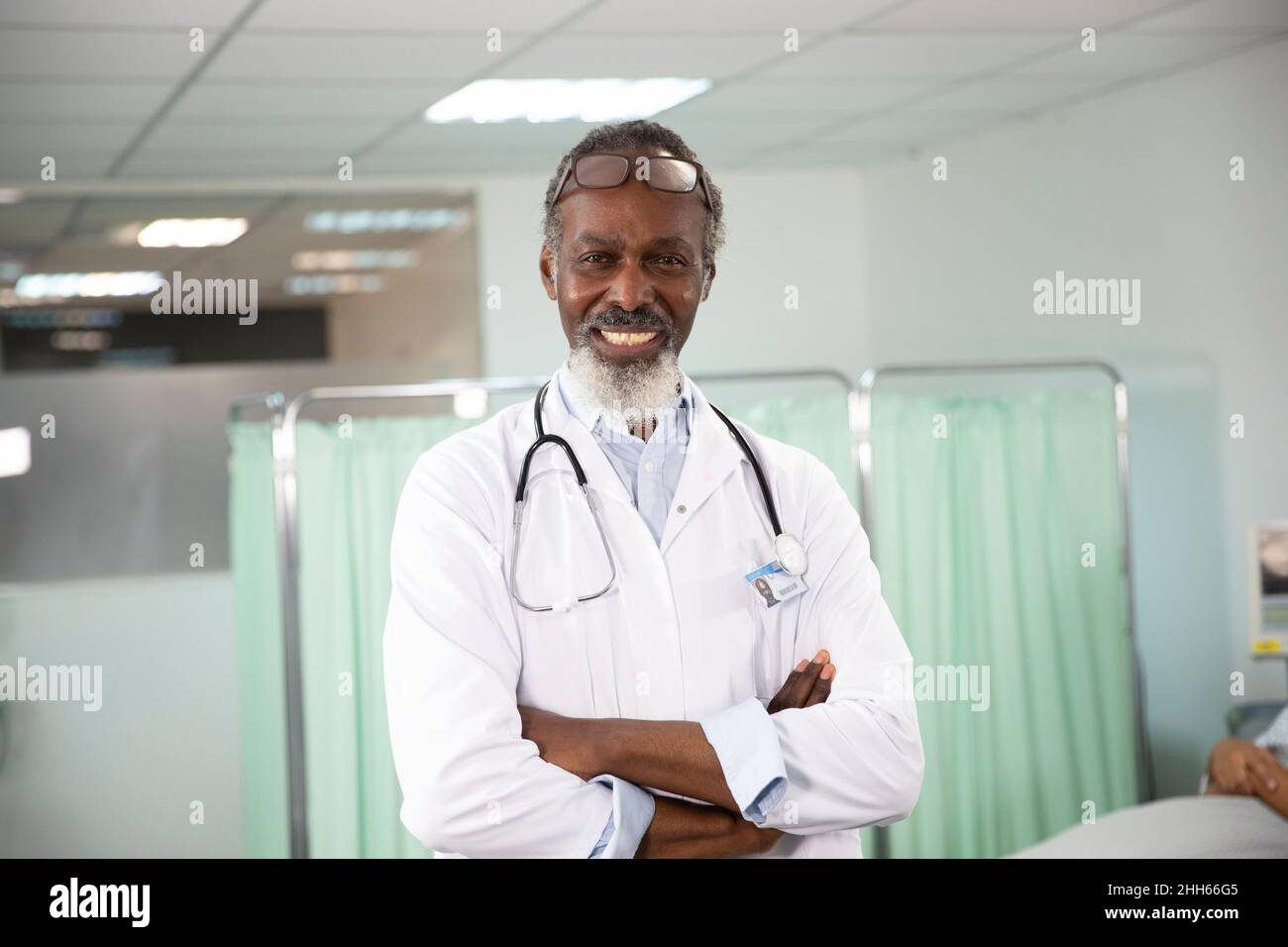Confident male doctor with arms crossed in medical room Stock Photo - Alamy