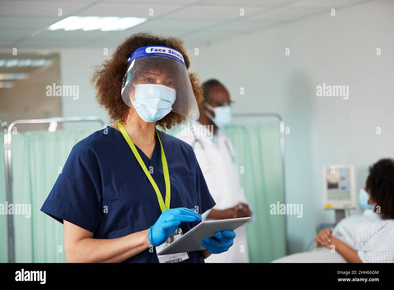 People using face shield hi-res stock photography and images - Alamy