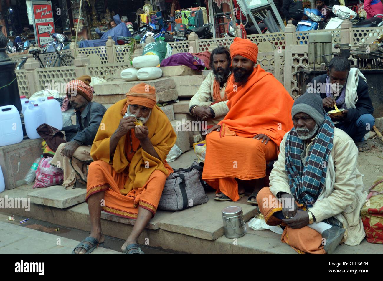 Sadhus chanting and reading letters by the Ganga River, Varanasi, in ...