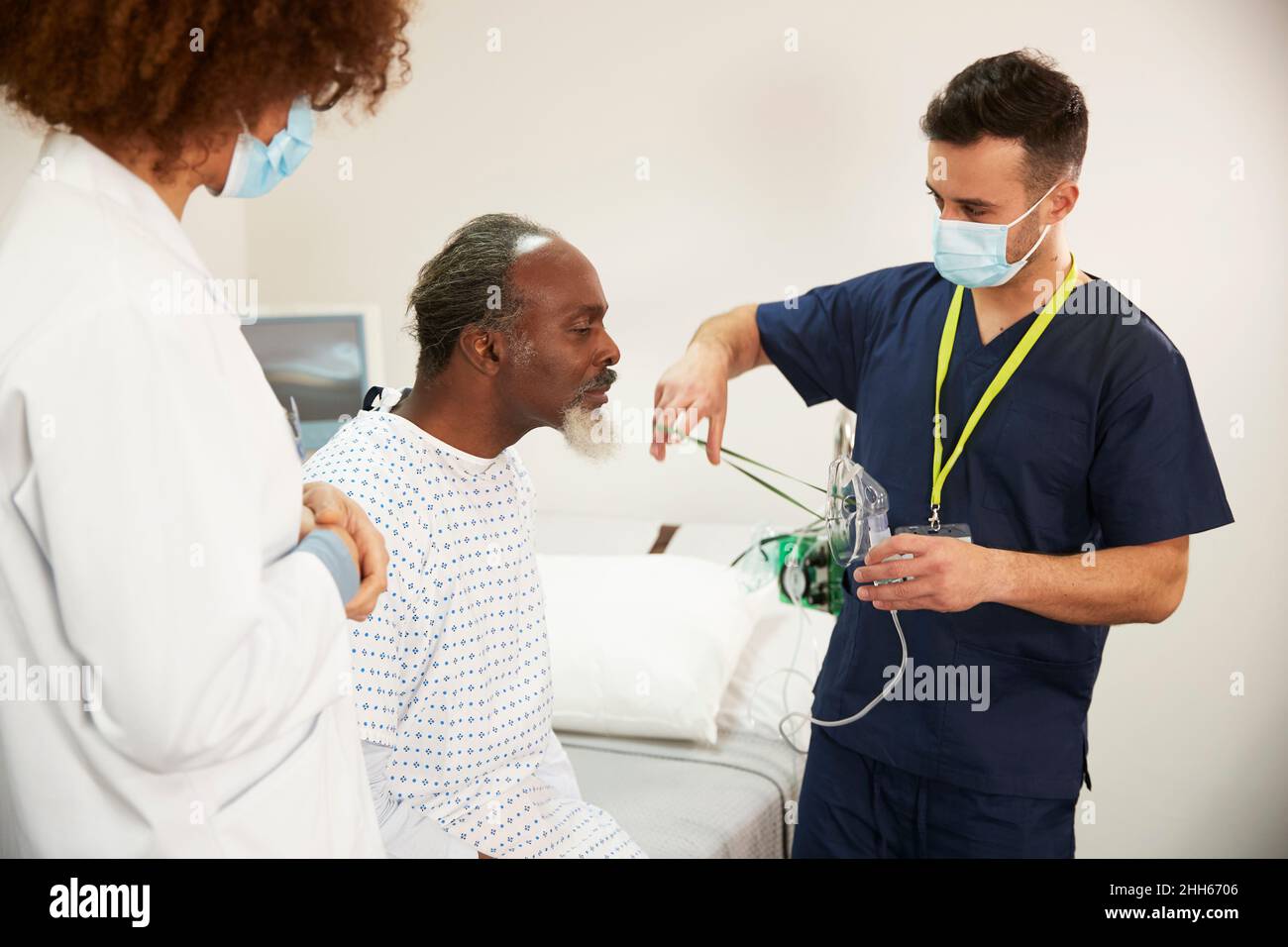 Nurse helping patient with oxygen mask at hospital Stock Photo - Alamy