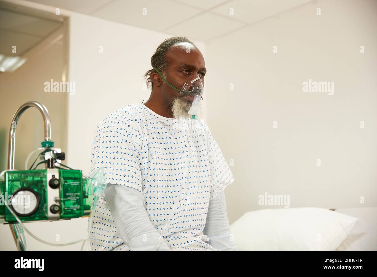 Ill patient wearing oxygen mask in medical room Stock Photo - Alamy