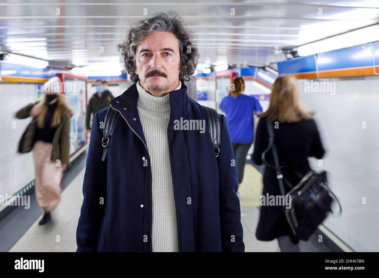Serious man standing at subway station Stock Photo - Alamy
