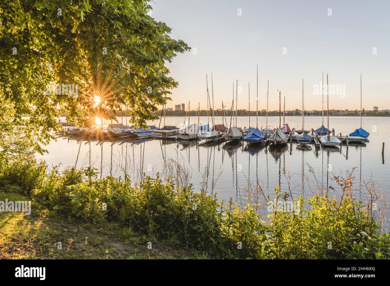 Germany, Hamburg, Sailboats moored along Outer Alster Lake jetty at ...