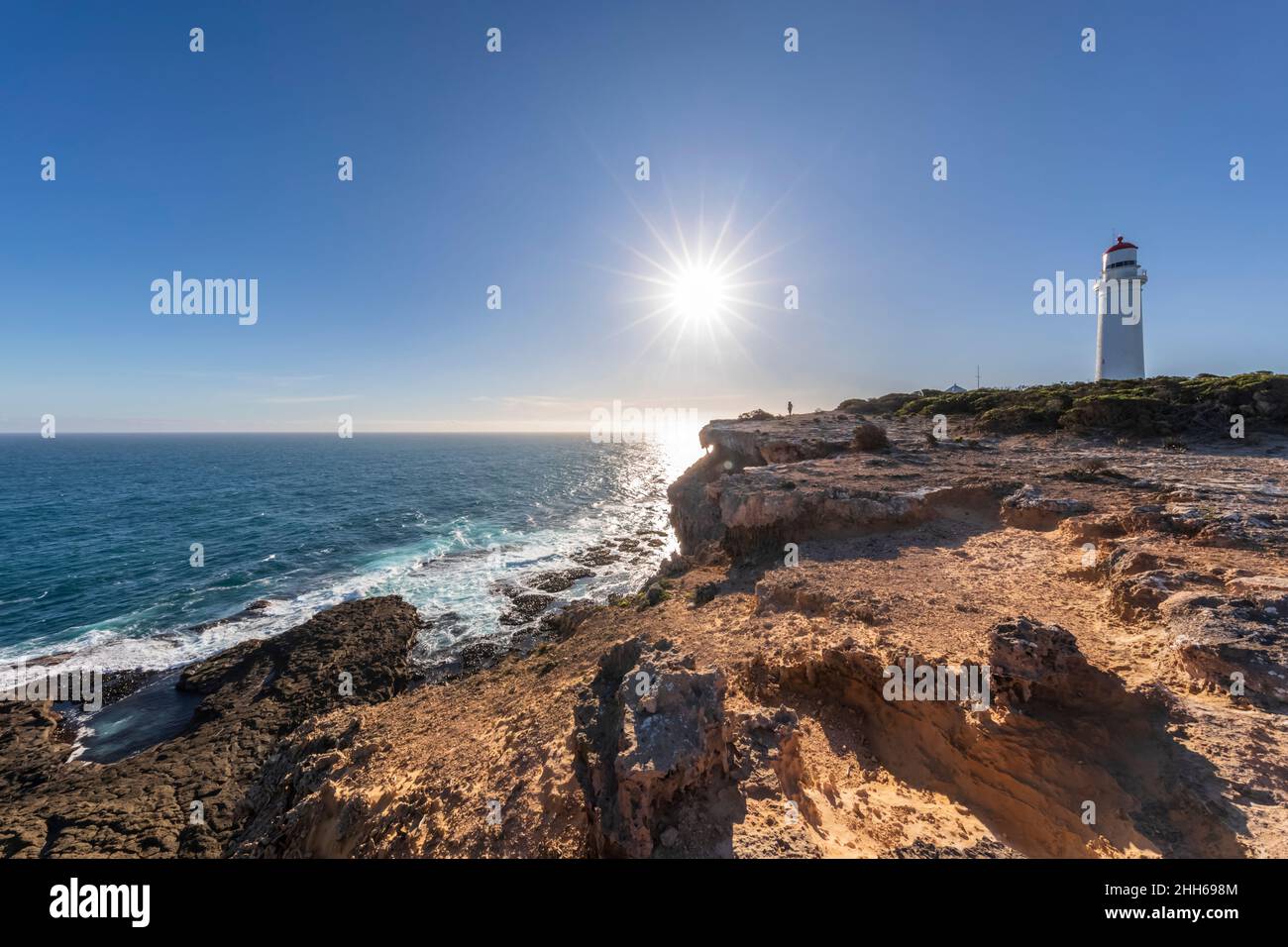 Australia, Victoria, Sun shining over rough coast of Cape Nelson State ...