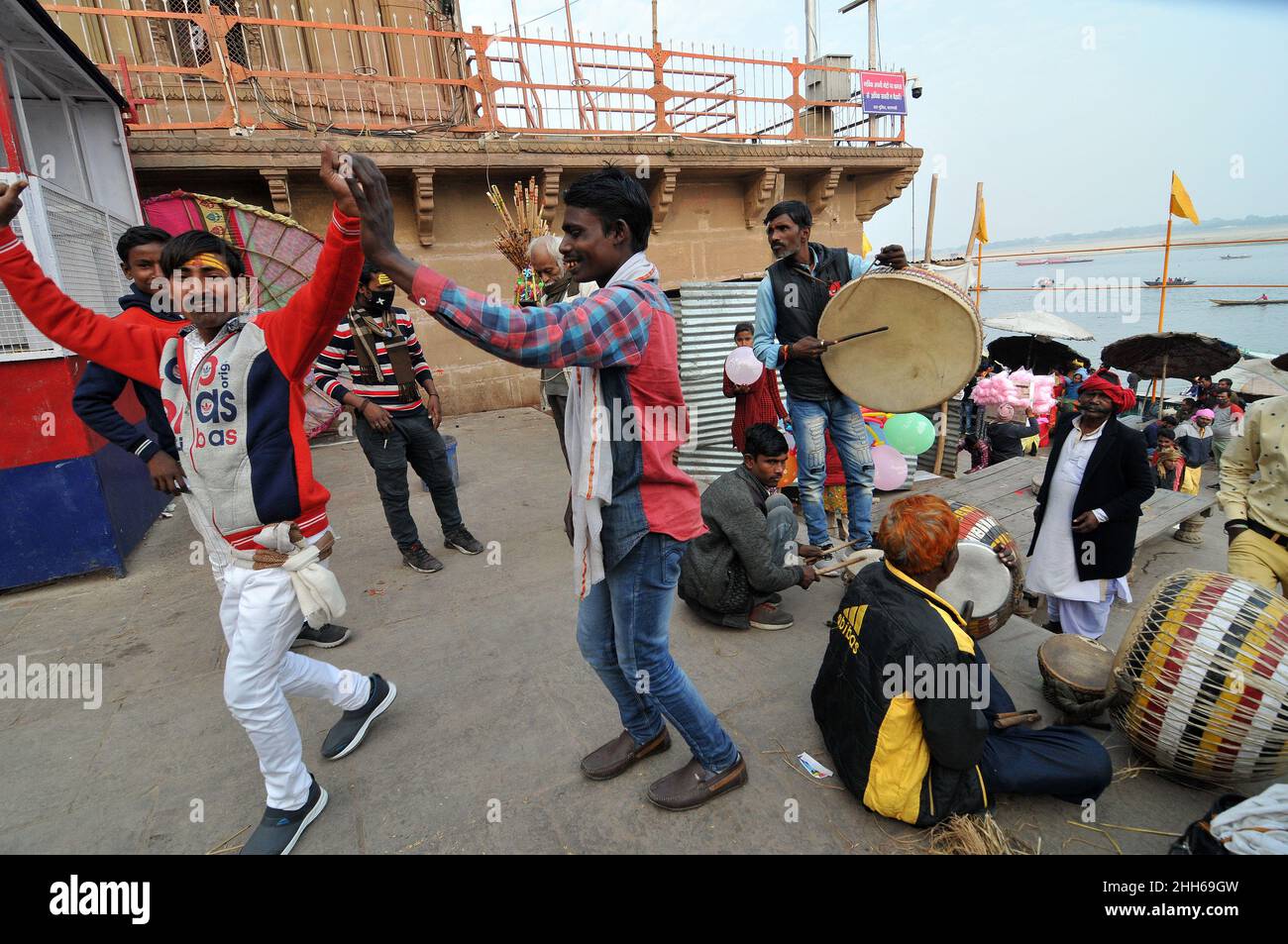 Men dance to the sound of traditional instruments by the Ganga River ...