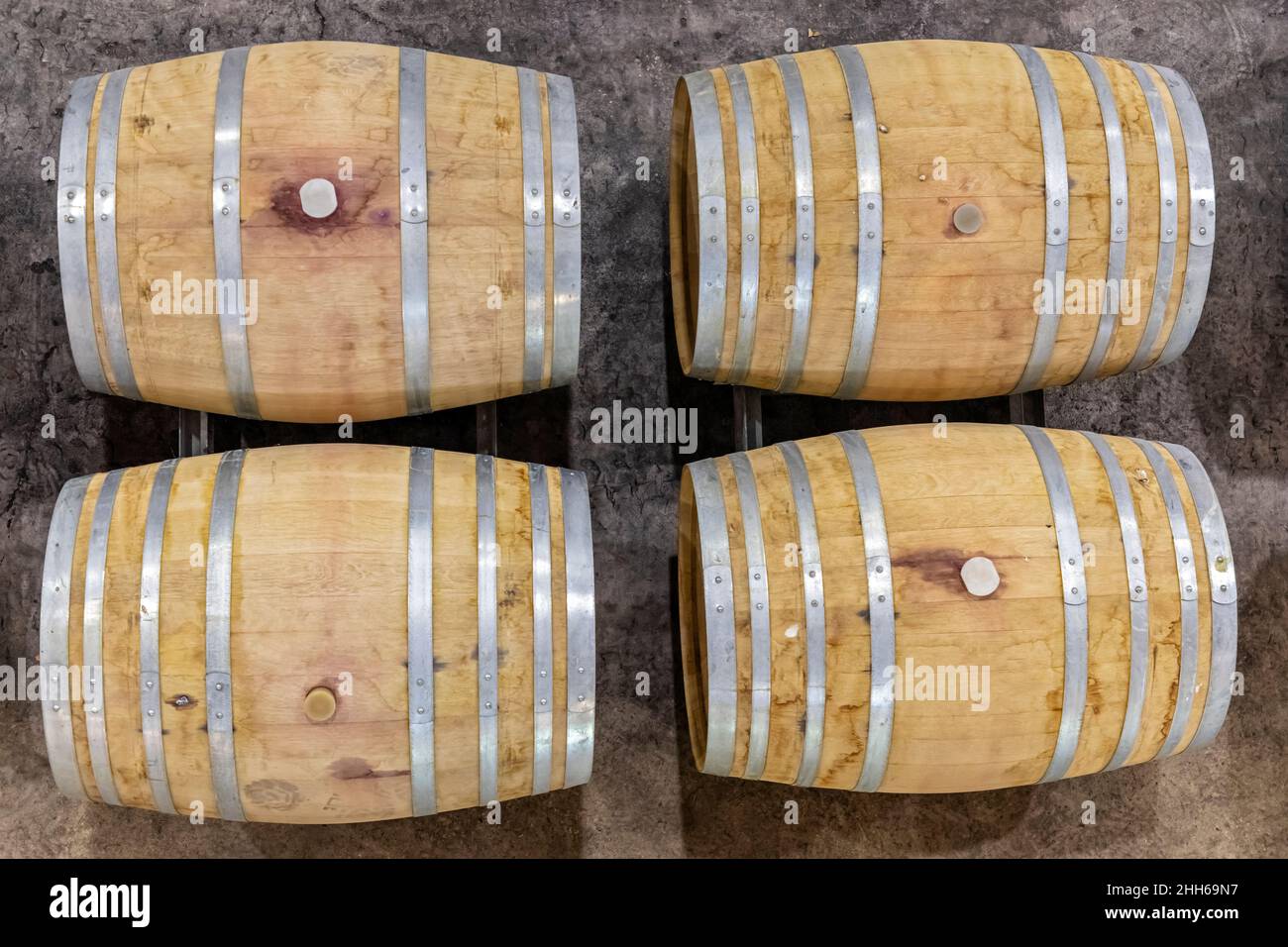 Four wine casks with metal reinforcements Stock Photo - Alamy