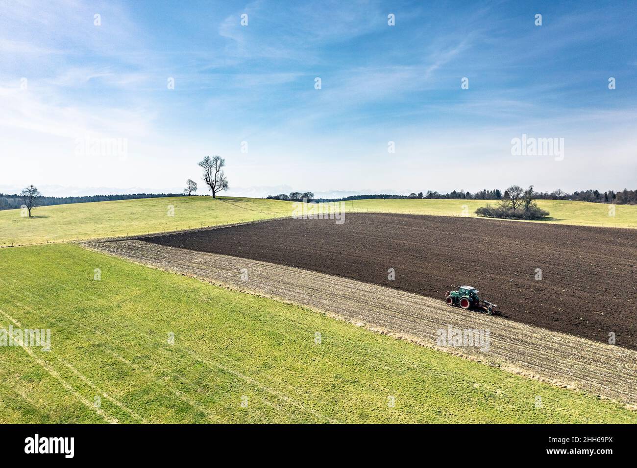 Aerial view of tractor plowing field in spring Stock Photo - Alamy