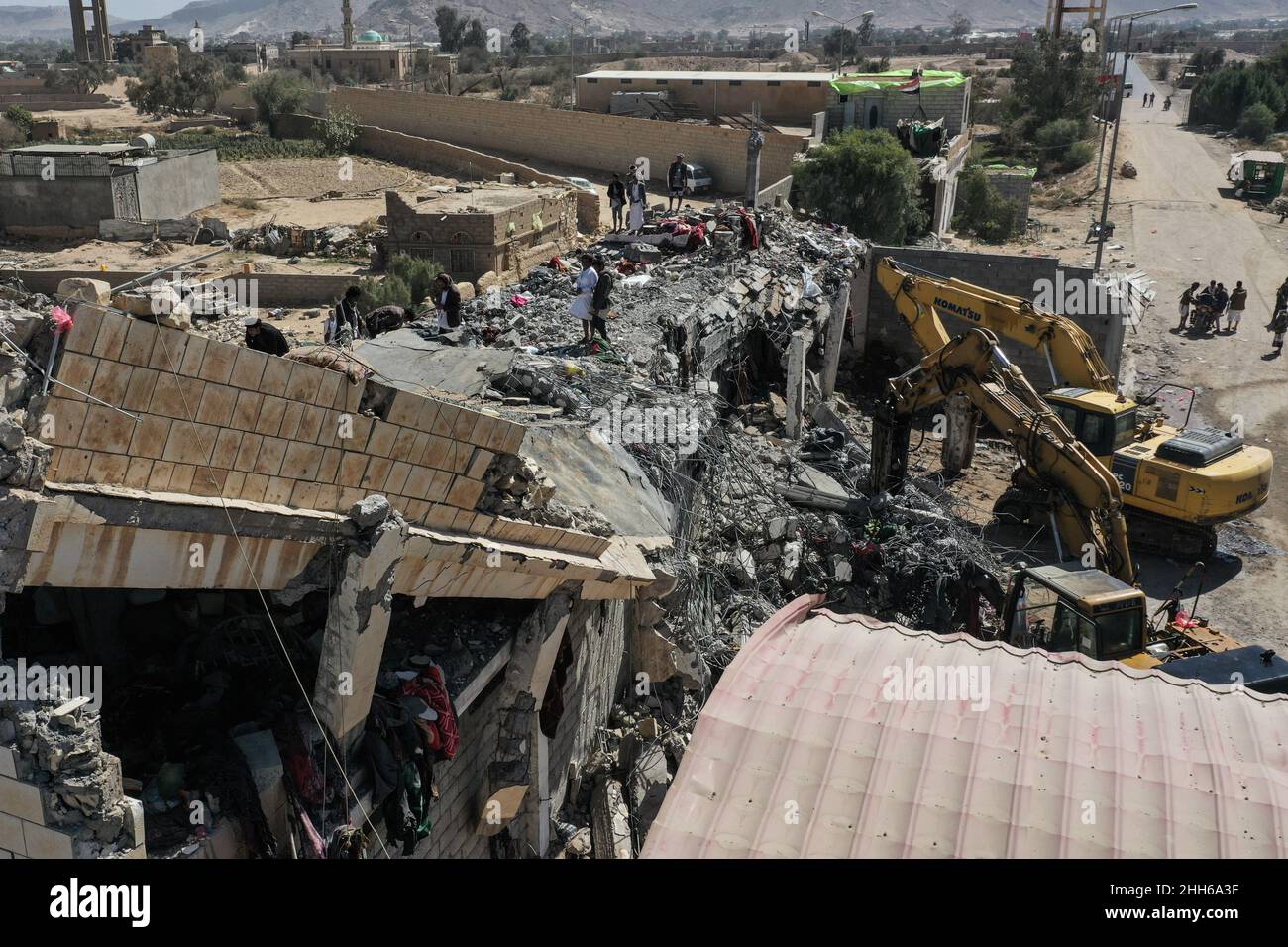 22 January 2022, Yemen, Sa'dah: Yemeni people inspect the rubble of a ...