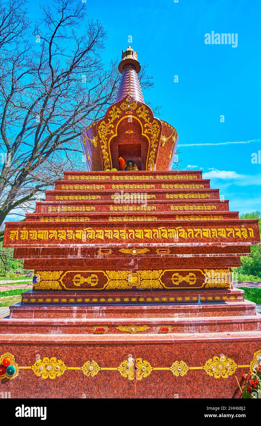 Closeup of the red stone Chorten (Stupa), decorated with Buddha ...