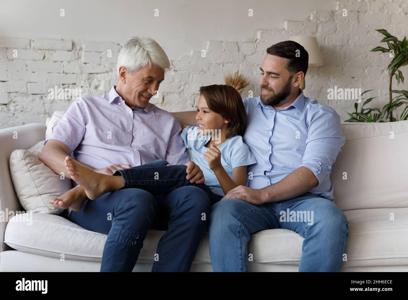 Senior grandpa, millennial father and boy enjoying family leisure time ...