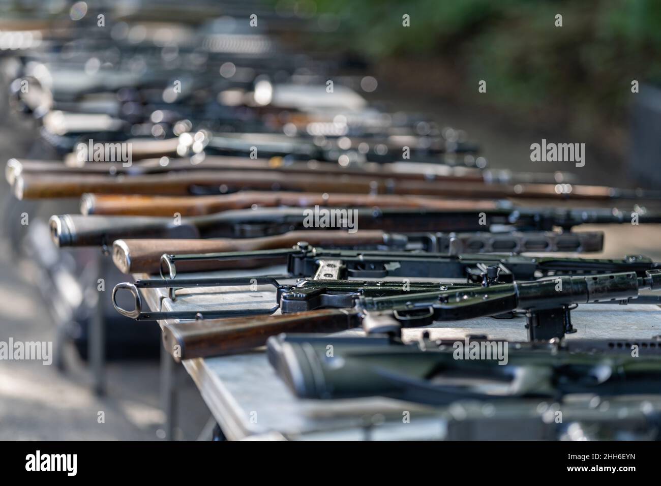 collection of historical and modern weapons on the shooting range Stock ...