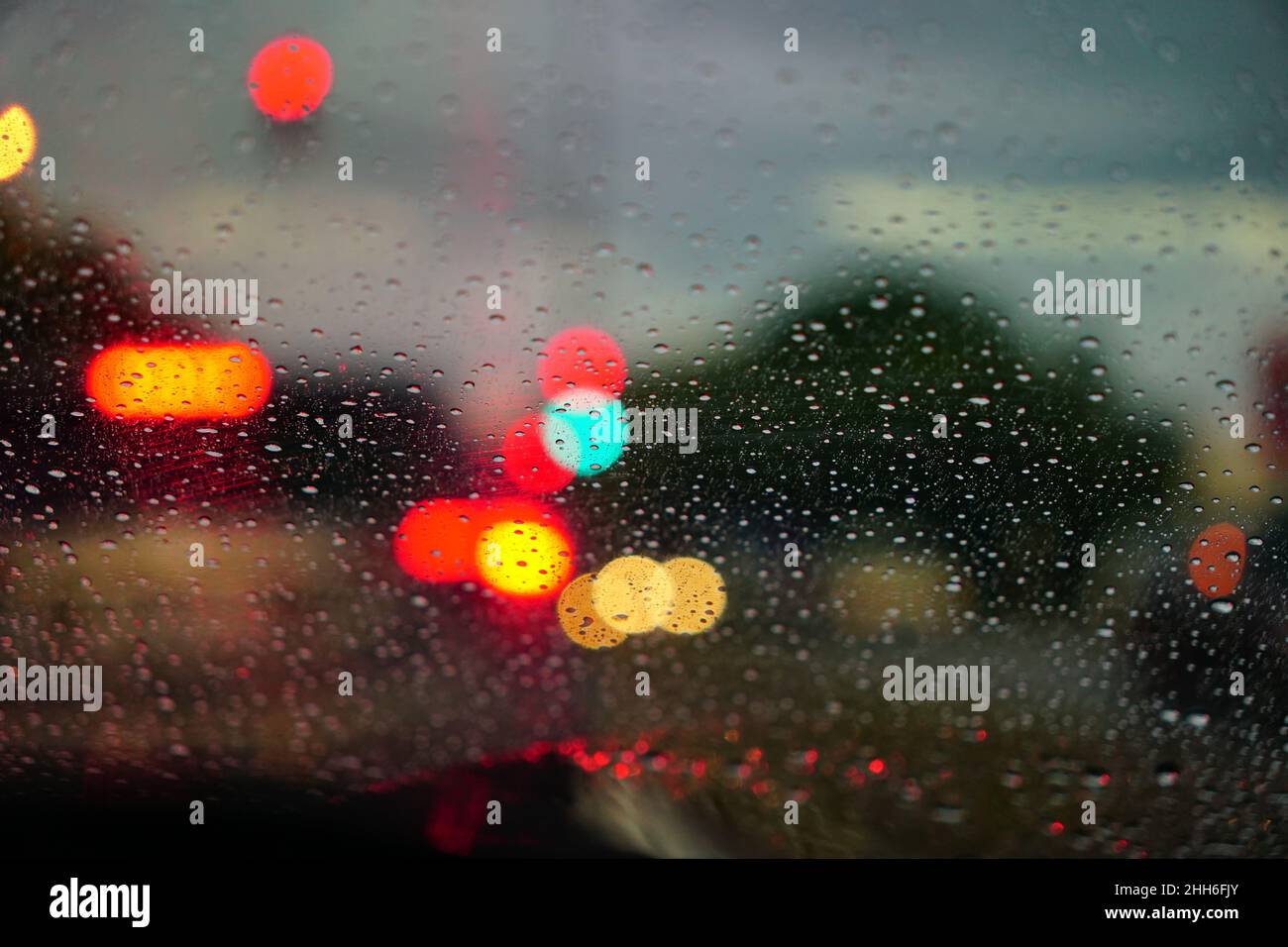 Traffic light bokeh with rain drops. Reflections of raindrops on glass ...