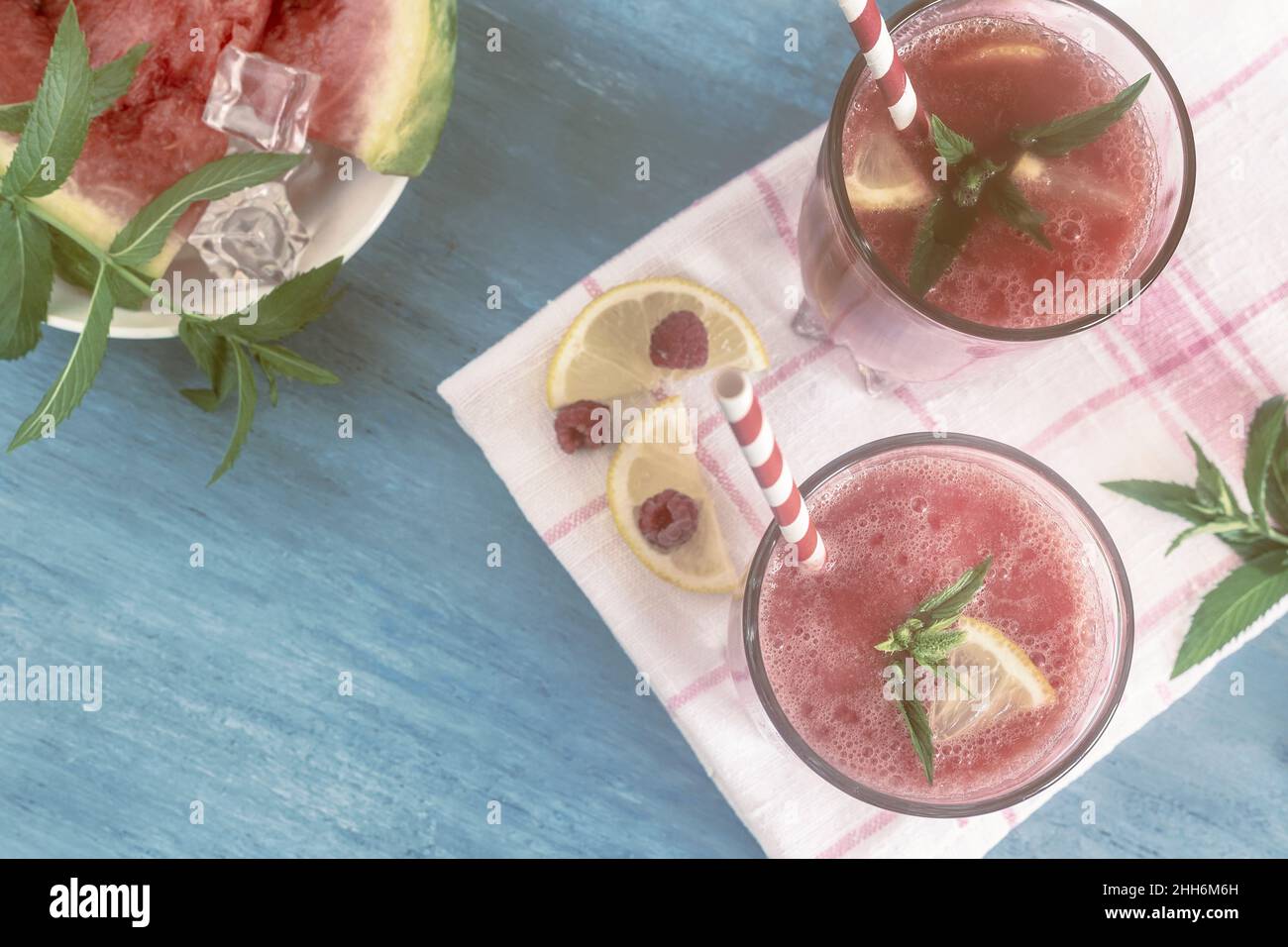 Fresh watermelon juice with raspberries and lemon in a glass. Slices of ...