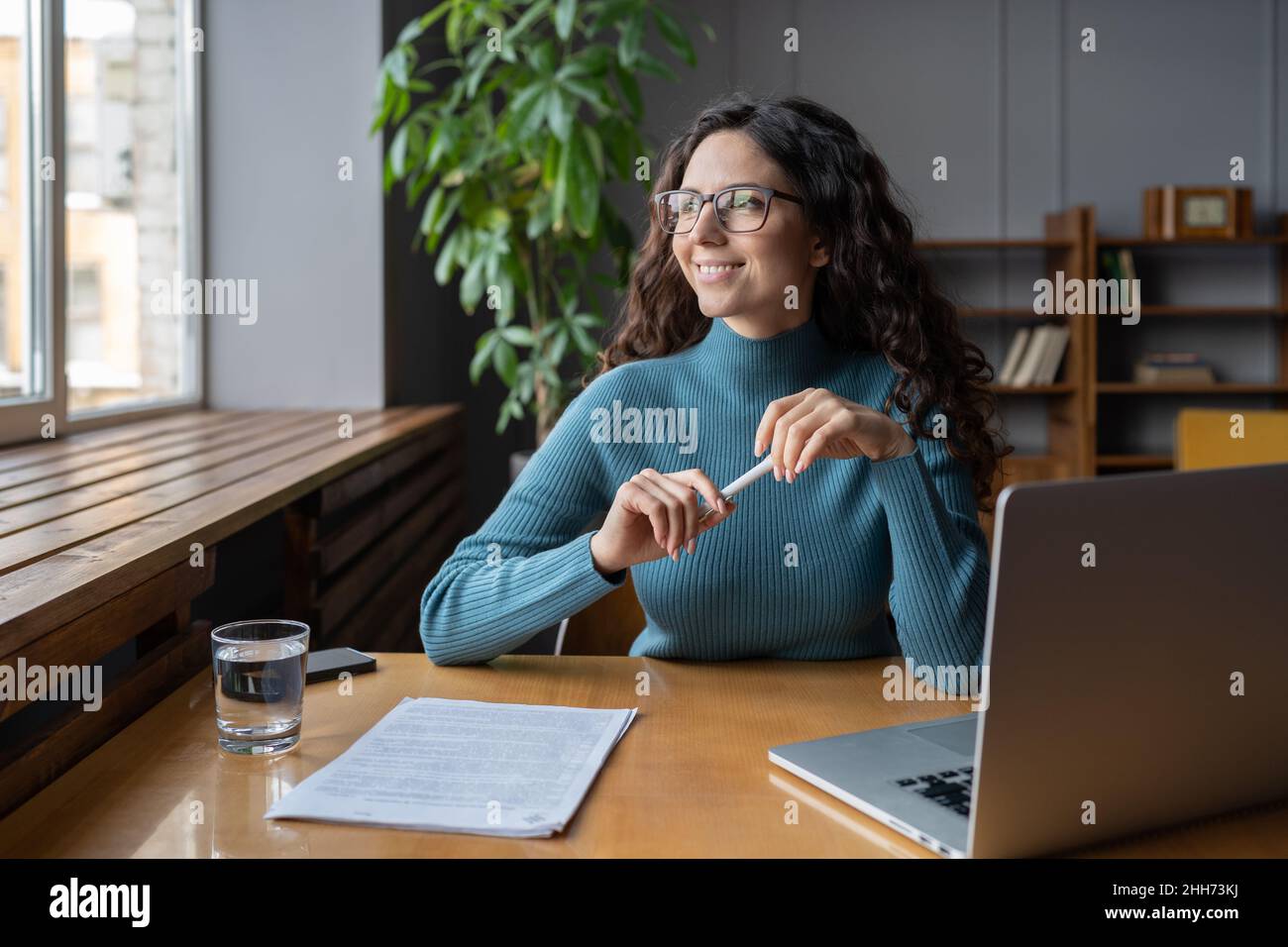 Employee wellbeing. Happy female office worker resting at workplace ...