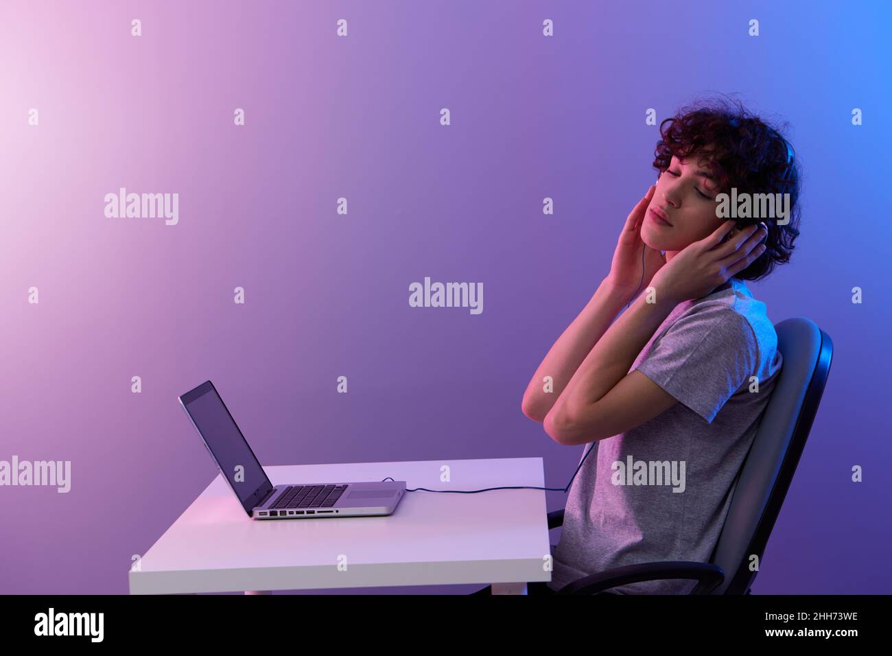 gamer in front of laptop entertainment violet background Stock Photo ...
