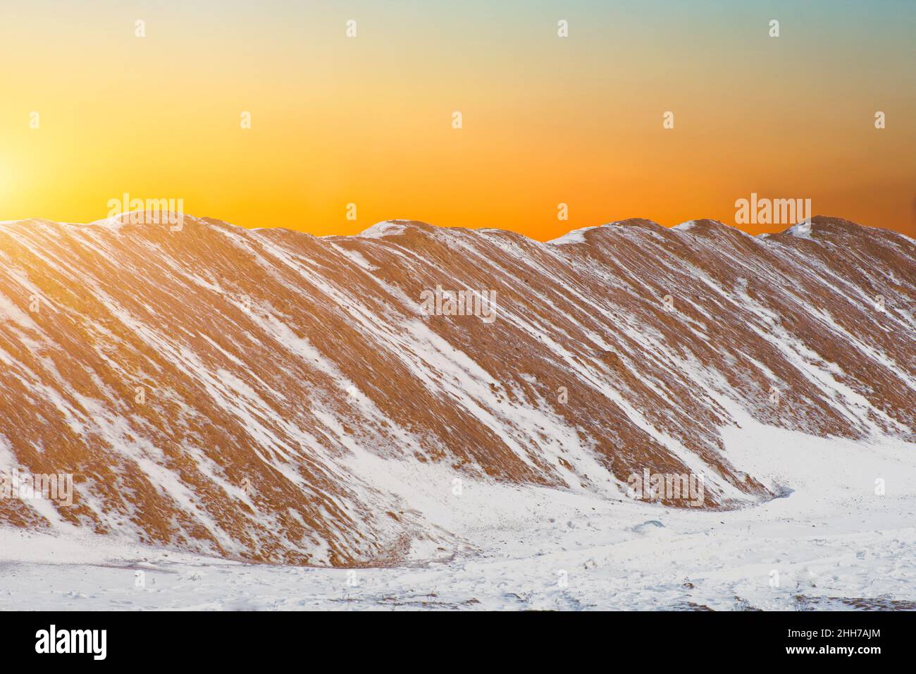 Sand dunes covered with white snow, ice, frost at sunset Stock Photo ...