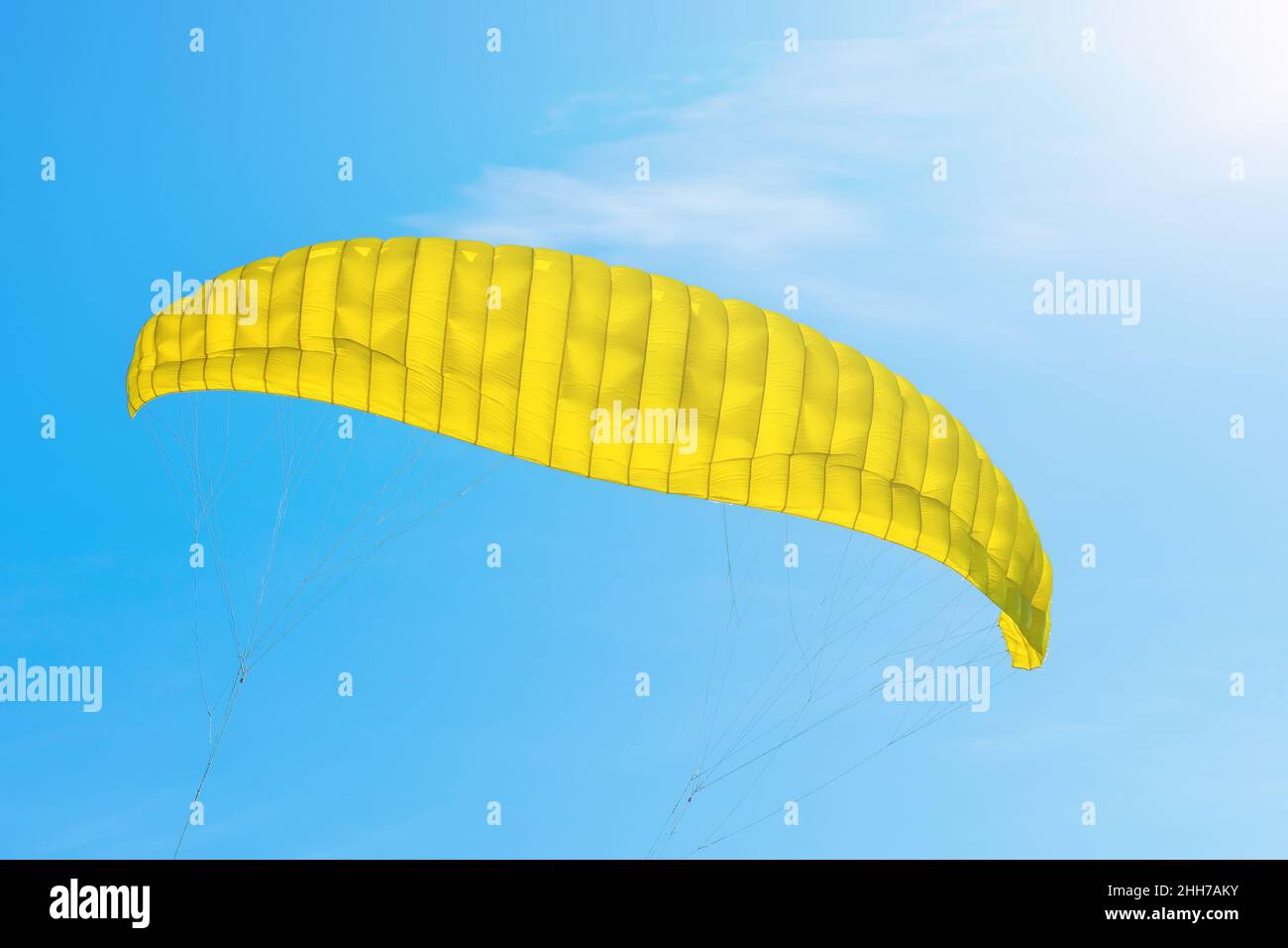 Flight yellow parachute in a blue sky Stock Photo - Alamy