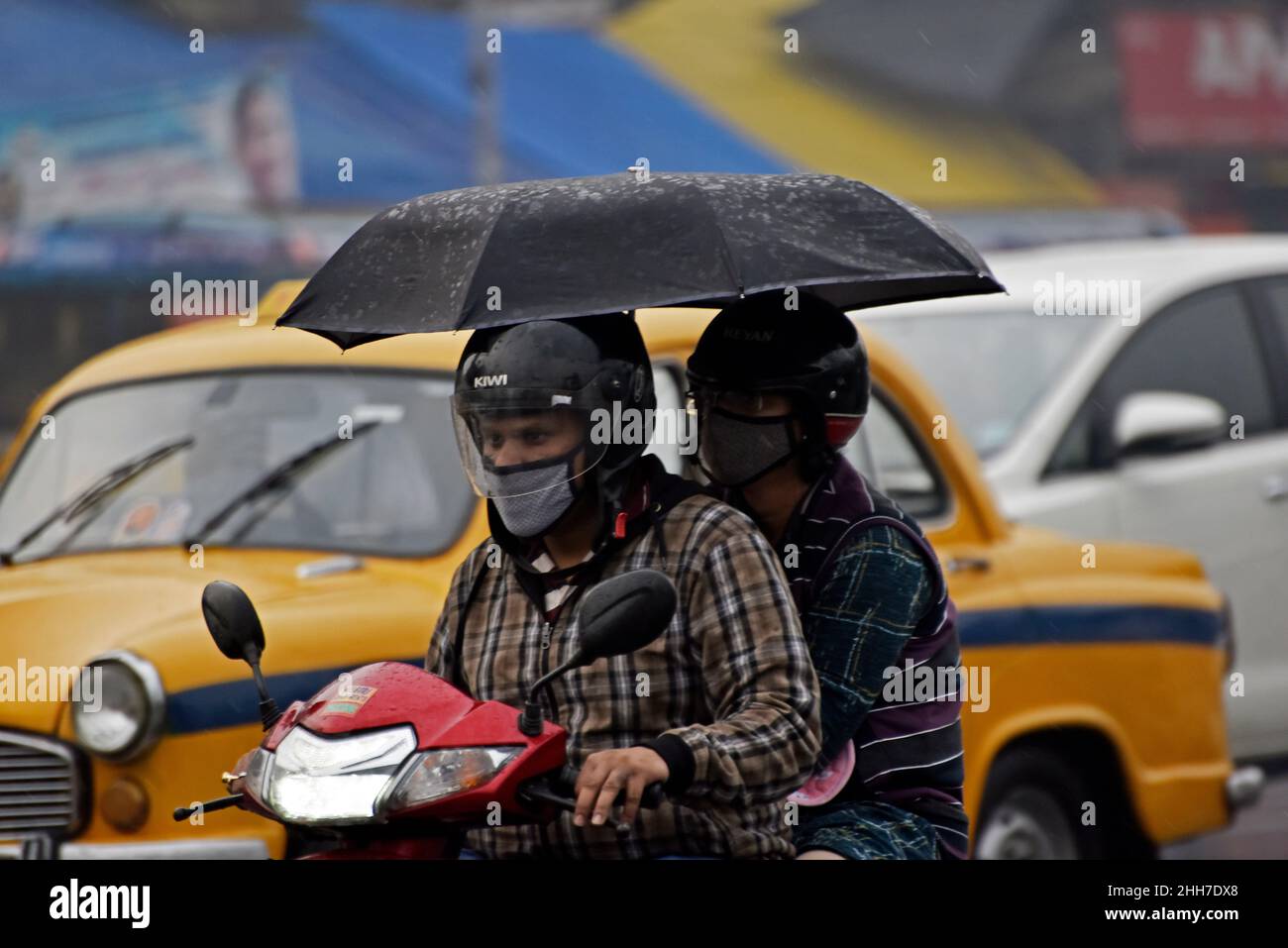 Kolkata, West Bengal, India. 23rd Jan, 2022. A pillion rider holds an ...