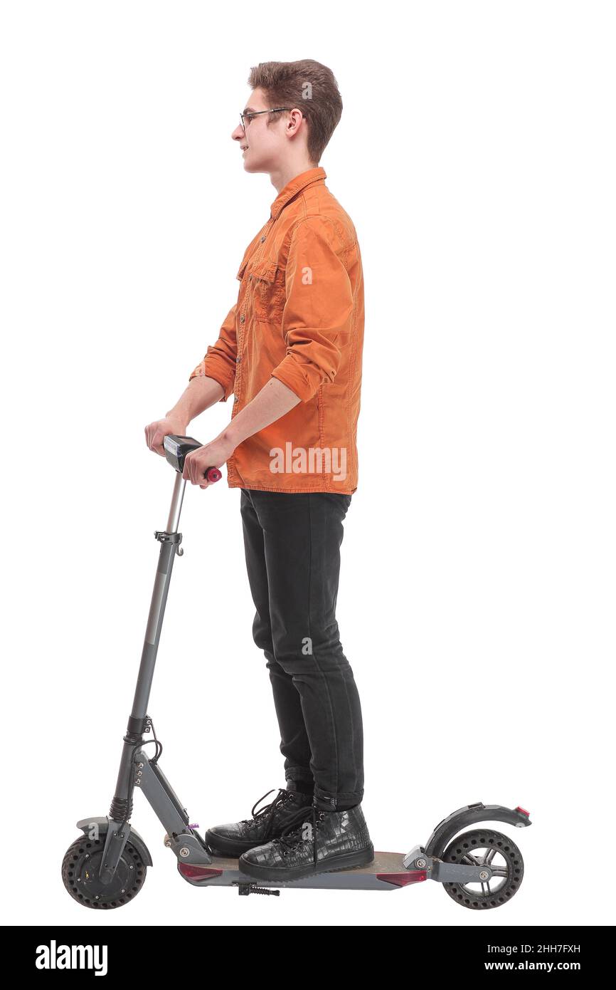 Full length side view portrait of an young man riding a scooter and ...