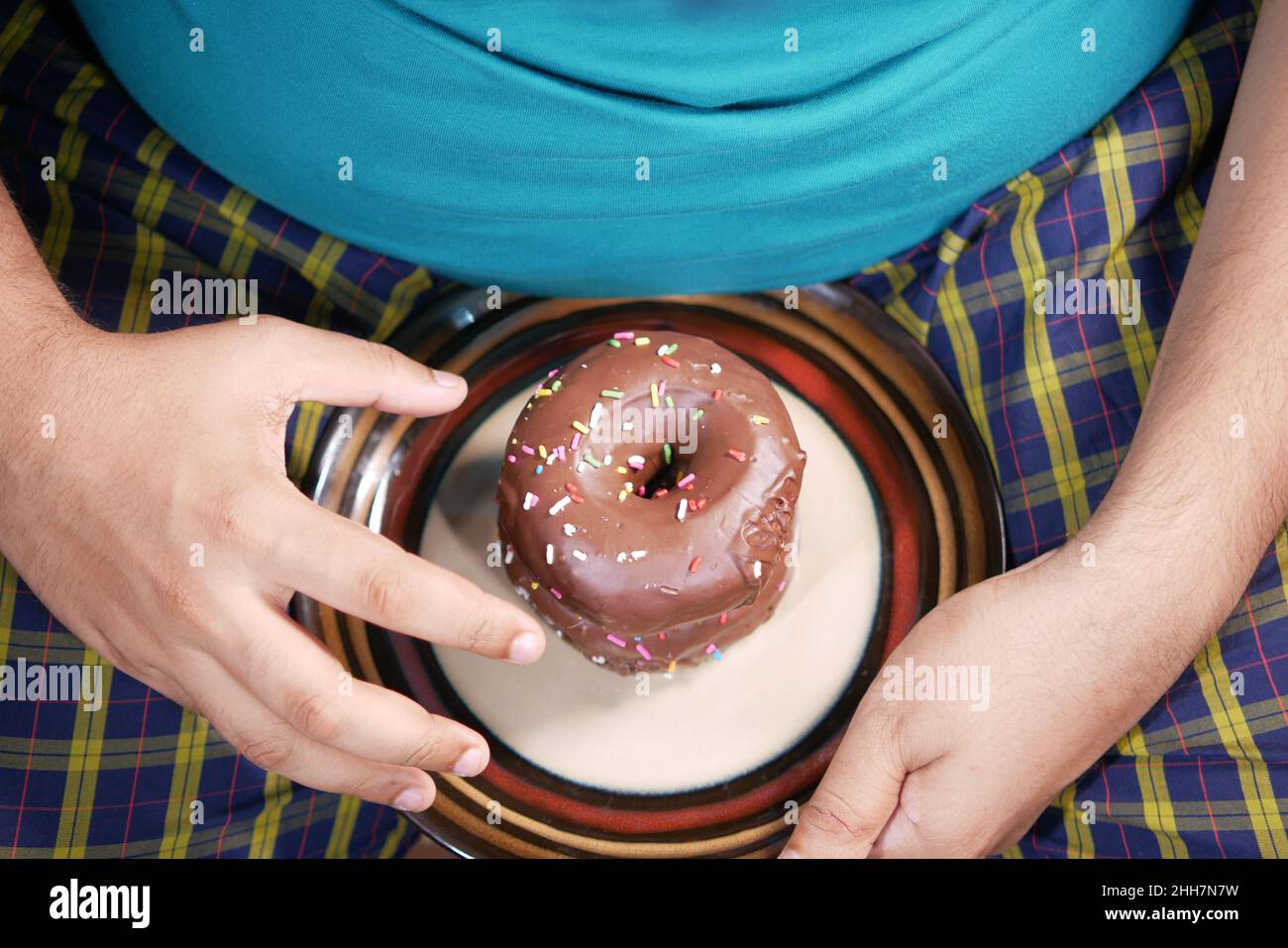 Young man eating donut hi-res stock photography and images - Alamy