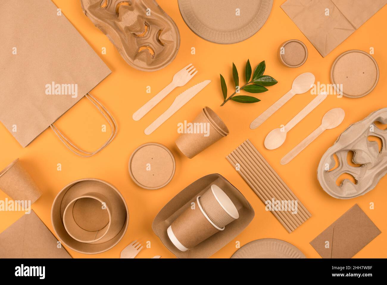 Eco-friendly tableware - kraft paper food packaging on yellow or orange ...