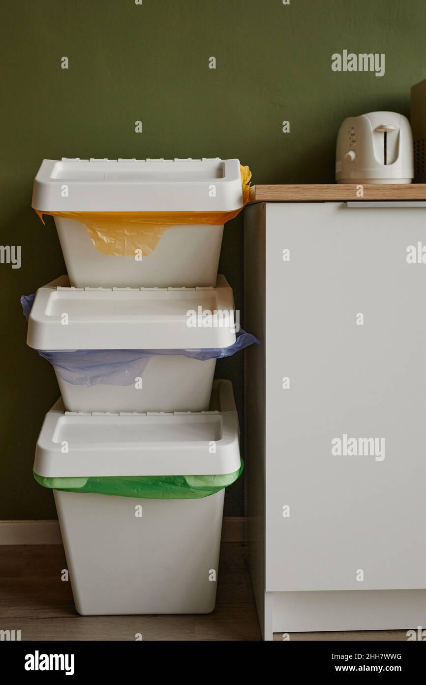 Vertical background image of three waste sorting containers stacked in ...