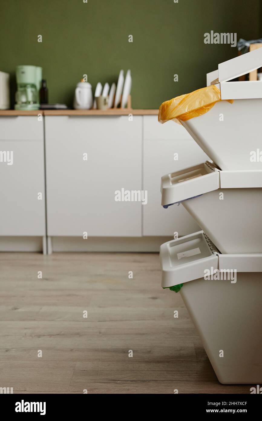 Vertical side view of three waste sorting containers stacked in kitchen ...