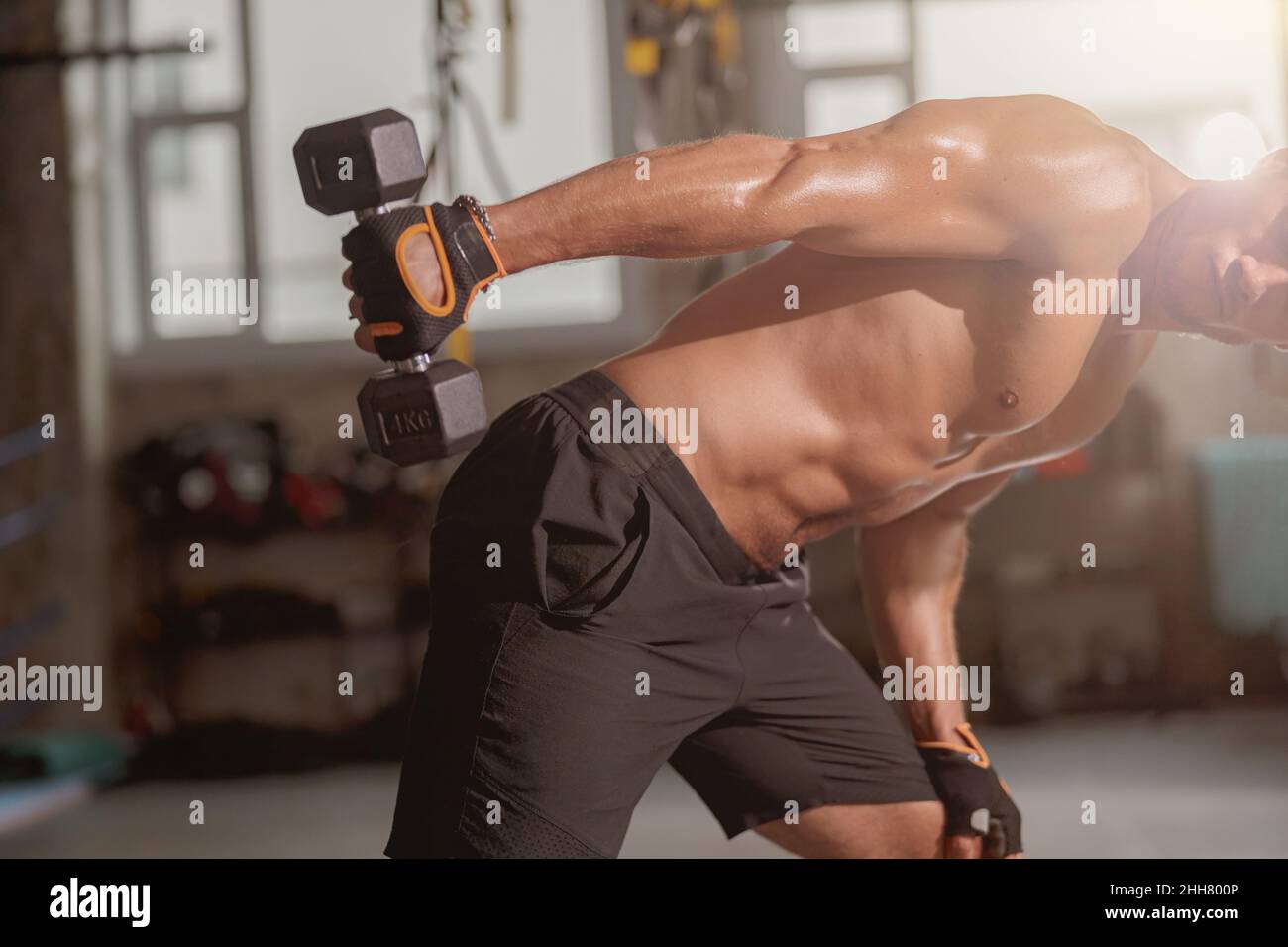 Muscular man working out in the fitness club Stock Photo - Alamy