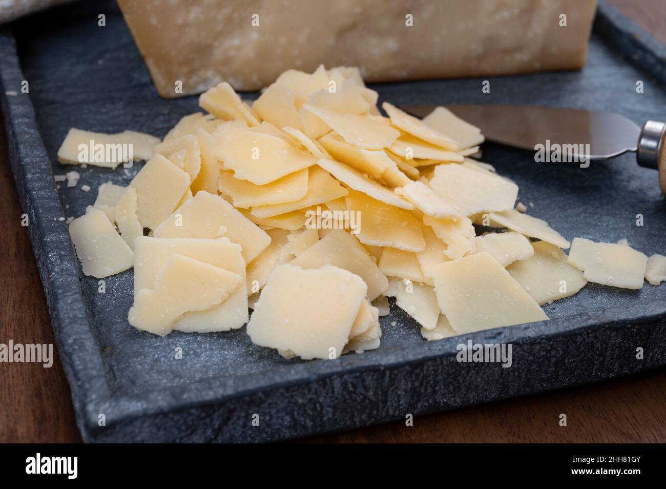 Flakes of parmesan cheese, italian hard parmigiano-reggiano cheese from ...