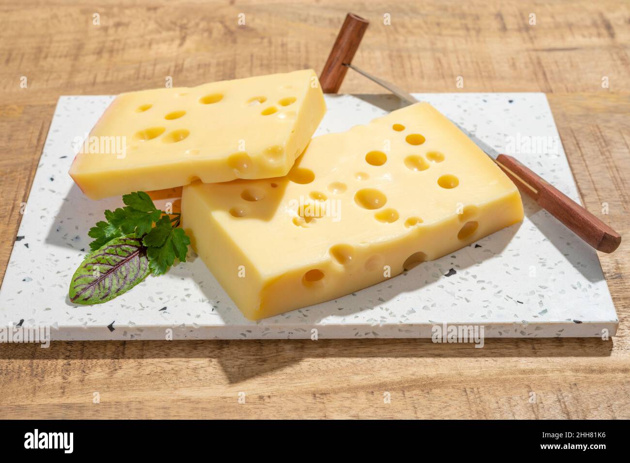 Cheese collection, blocks of French emmentaler cheese with many round ...