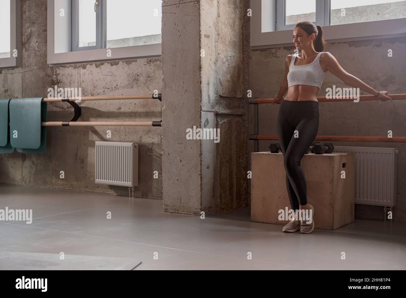 Young slender woman standing in the fitness club Stock Photo - Alamy