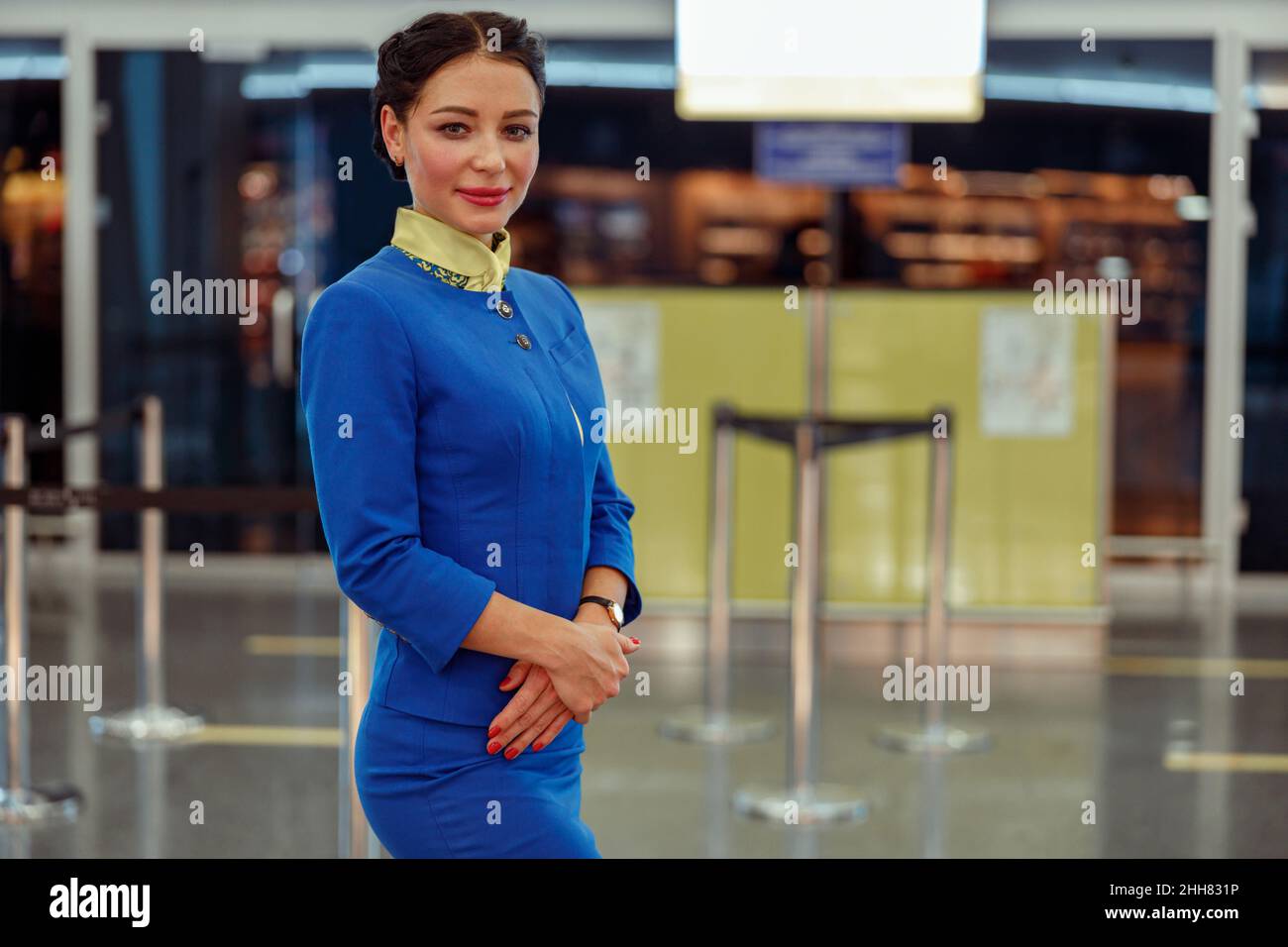 Stewardess or air hostess standing in airport terminal Stock Photo - Alamy