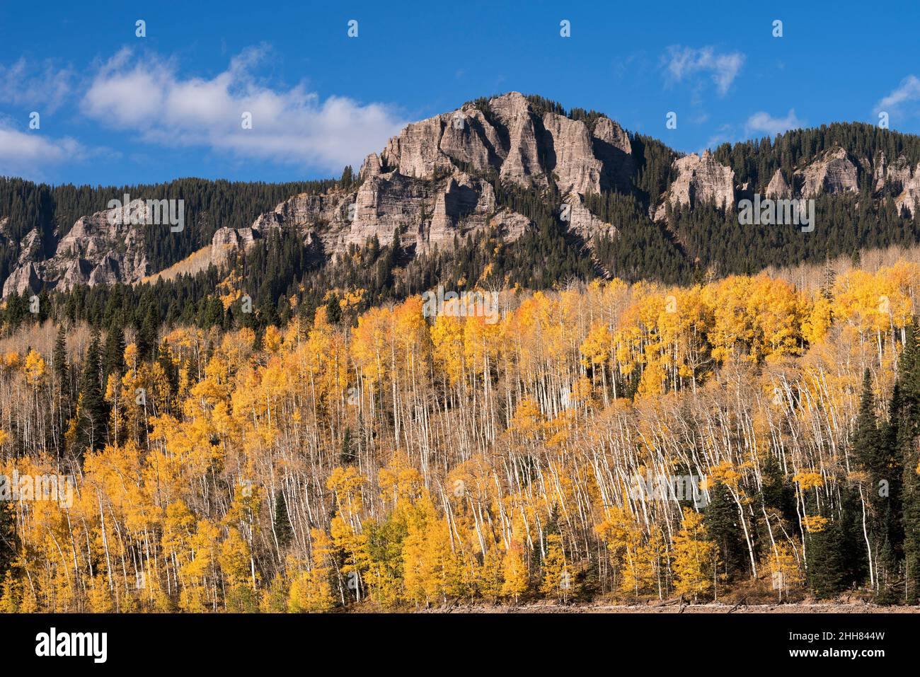 A wooden corral is towered by a colorful autumn Landscape in the ...