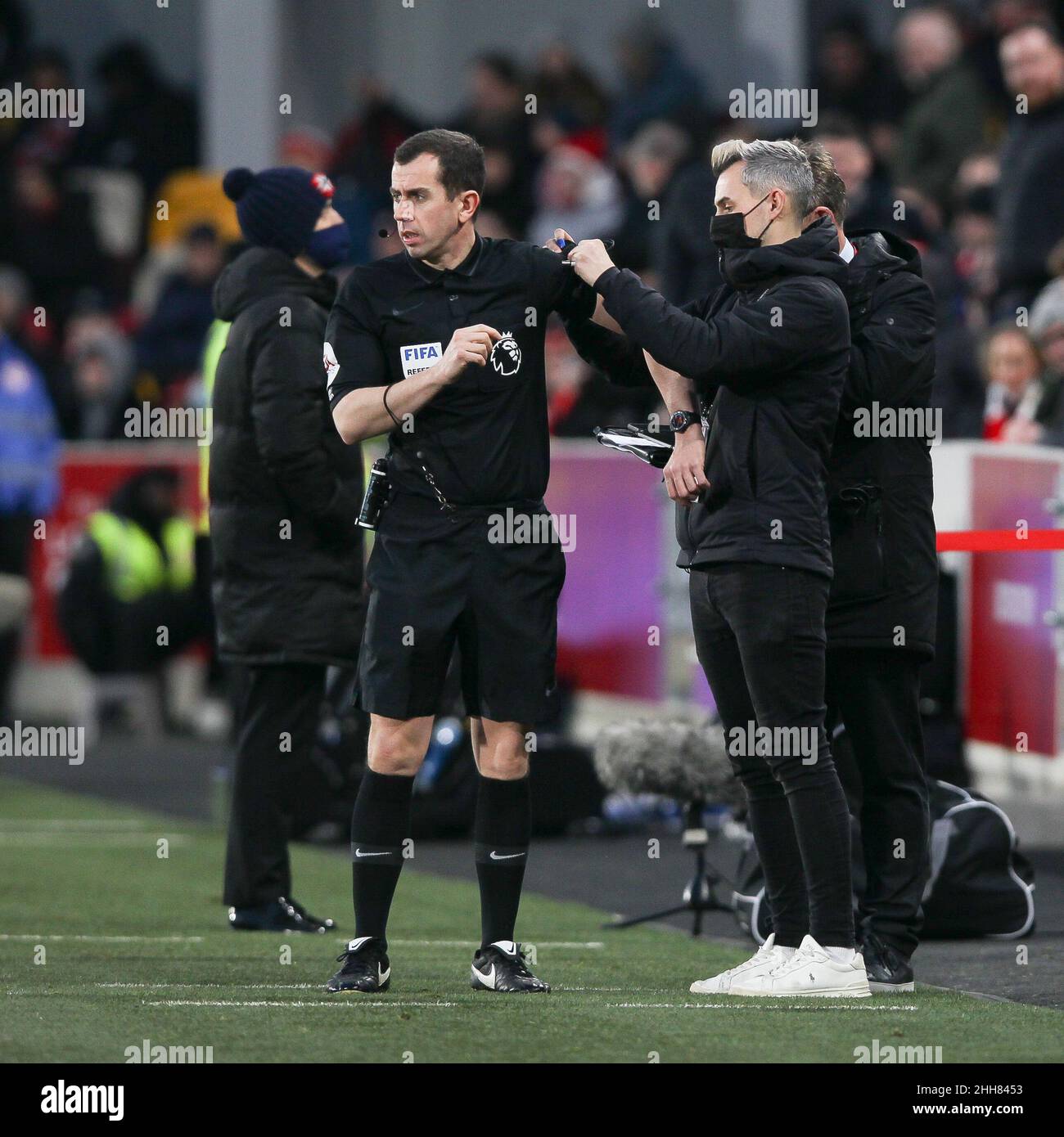 London, UK. 23rd Jan, 2022. Referee Peter Bankes has trouble with his ...