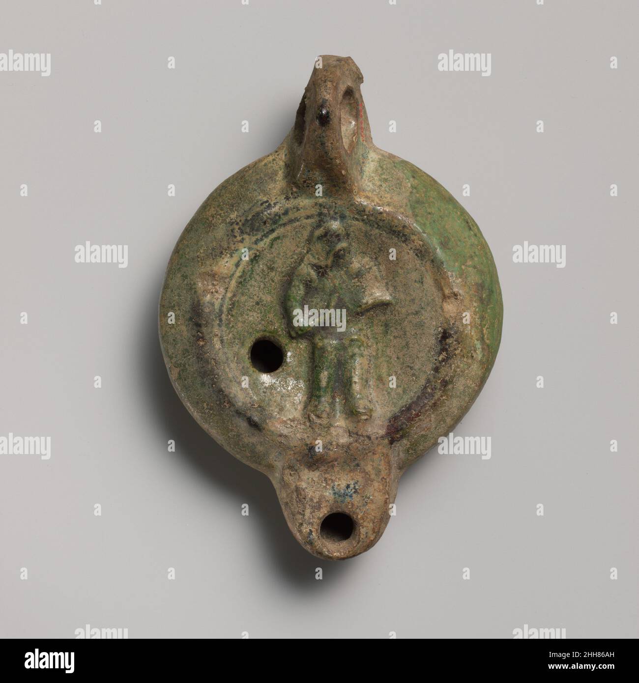Terracotta lamp late 1st–2nd century A.D. Roman In the discus stands a ...