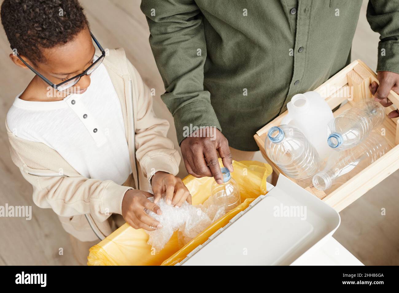 Top view at African-American father and son sorting household waste at ...