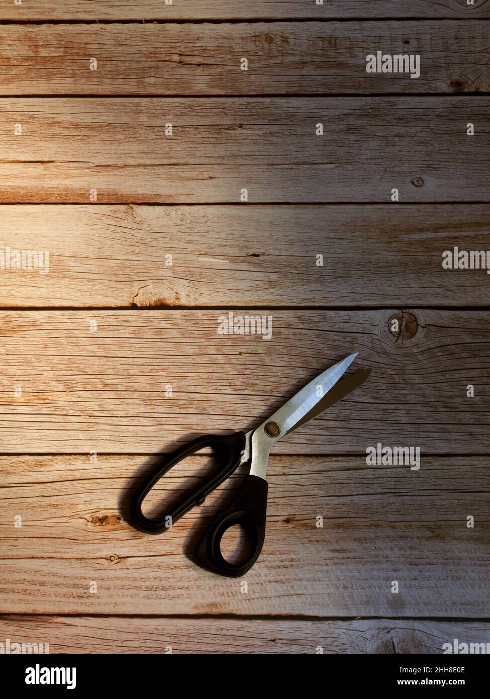 professional fabric cutting scissors on wood background and natural ...