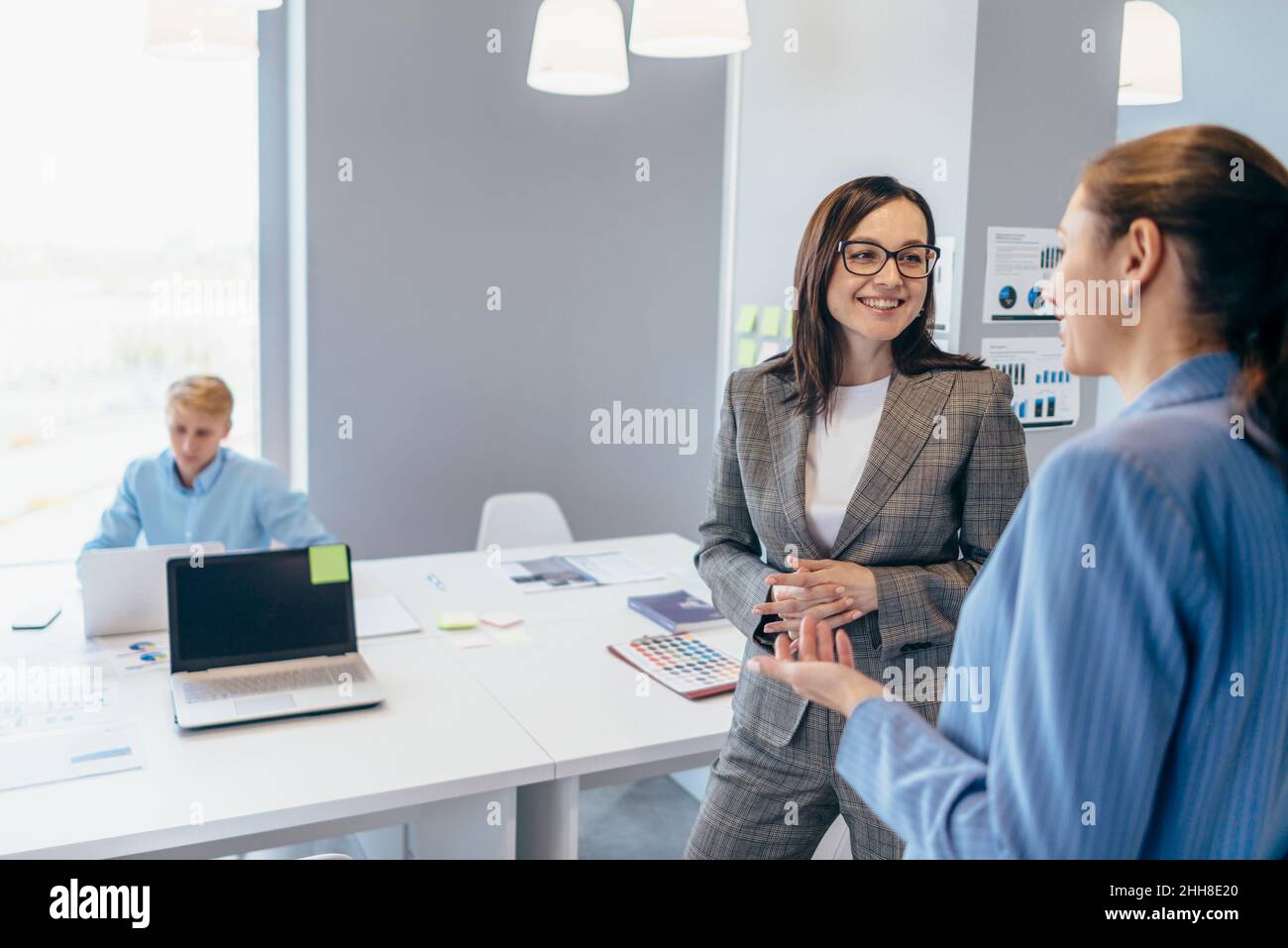 Business women standing in the office and talking Stock Photo - Alamy