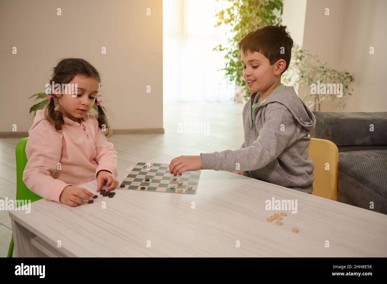 Two adorable European elementary aged kids, boy and girl, brother and ...