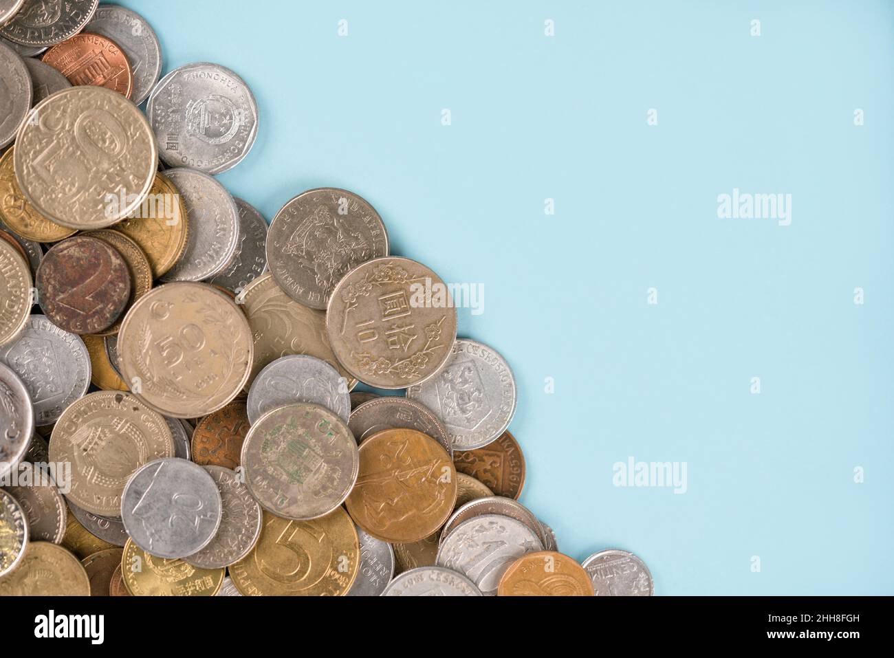 Variety of old coins on light blue background with copy space. Various ...