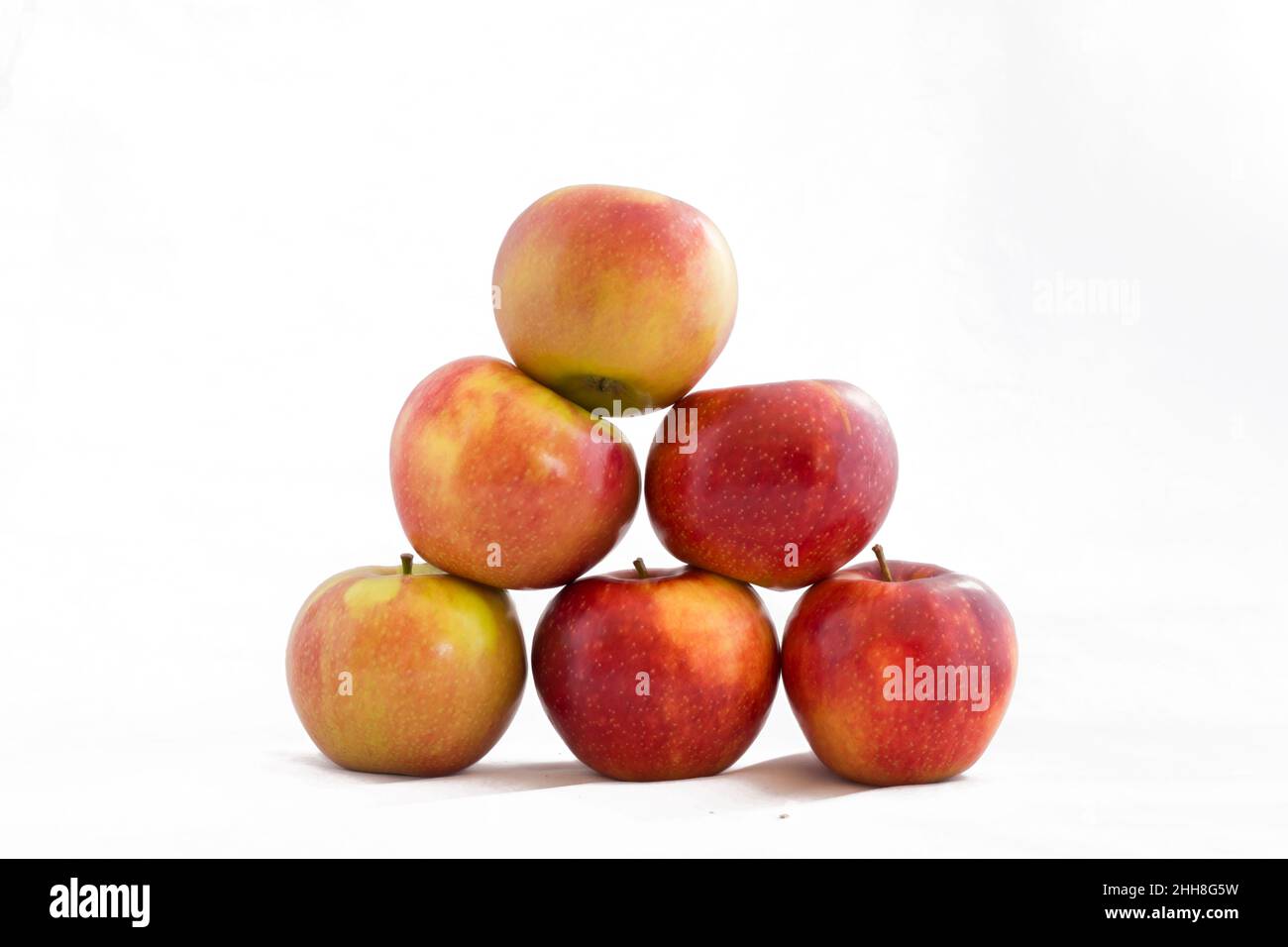 Stack of organic apples in the shape of a pyramid isolated on a white ...
