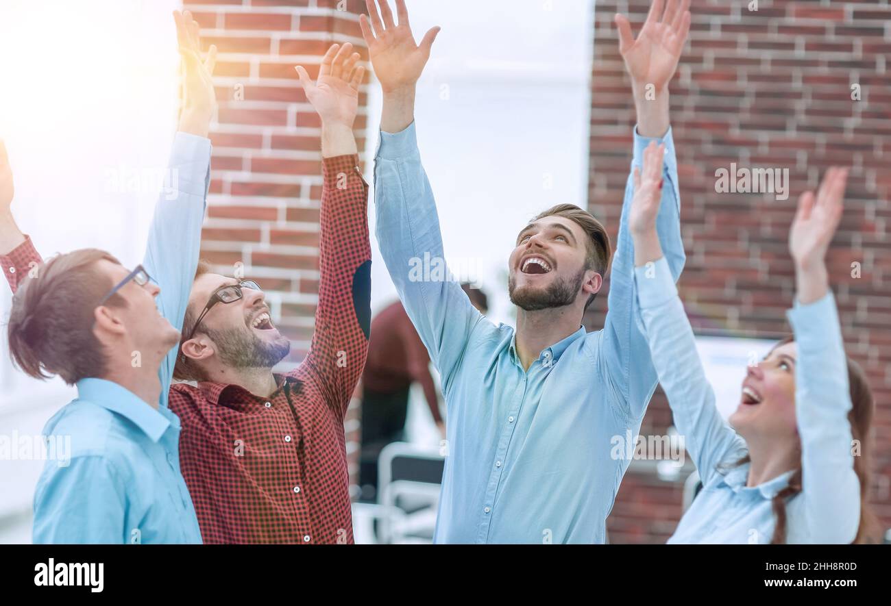 Business team celebrating a triumph with arms up Stock Photo - Alamy